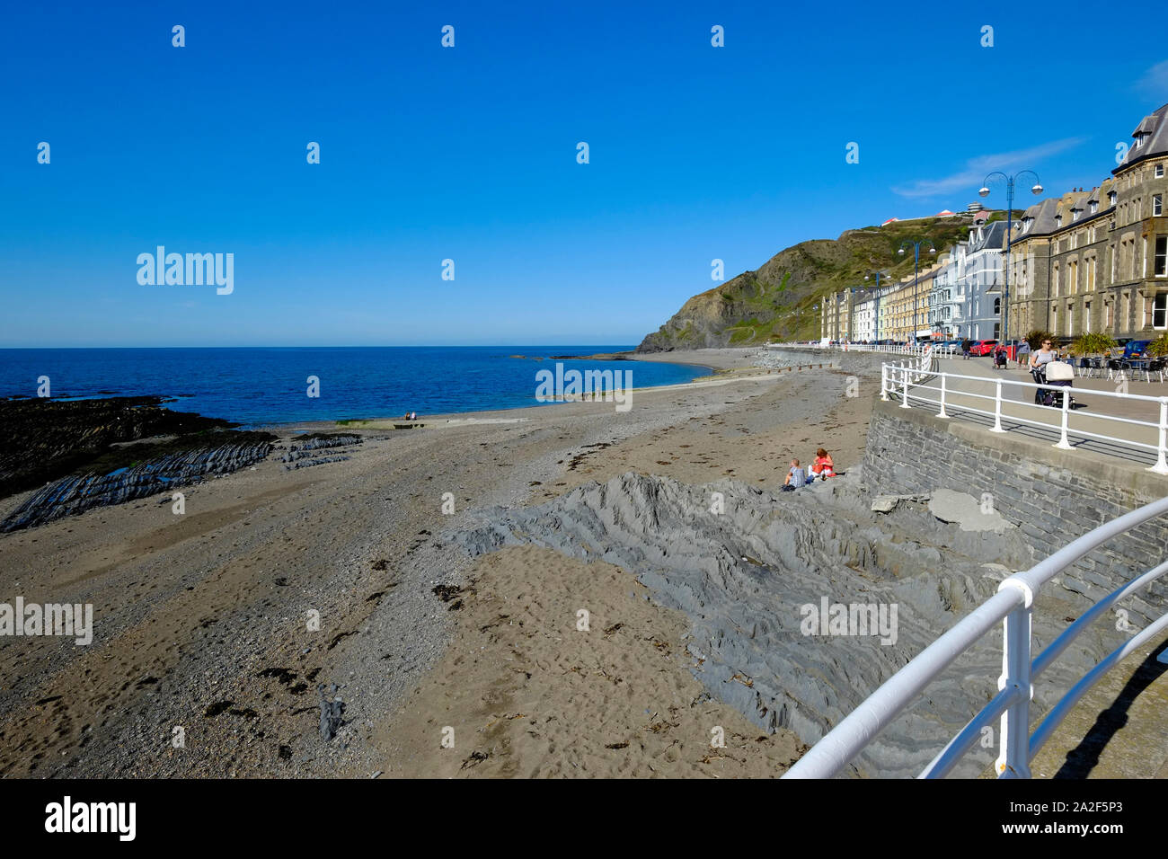 Aberystwyth Town Seafront beach and promenade at low tide in the bright ...