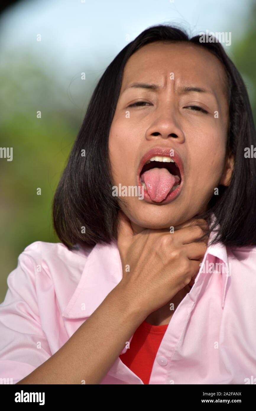A Choking Youthful Asian Female Stock Photo - Alamy