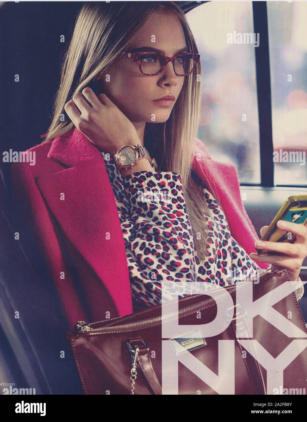 poster advertising DKNY fashion house with Cara Delevingne in paper ...