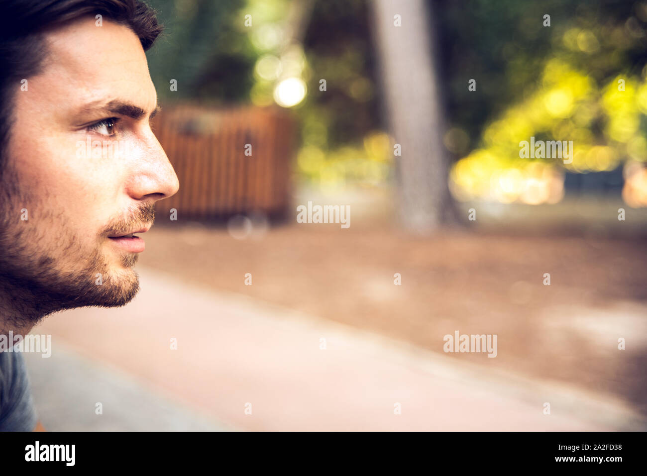 Profile portrait of young male model looking forward, negative space ...