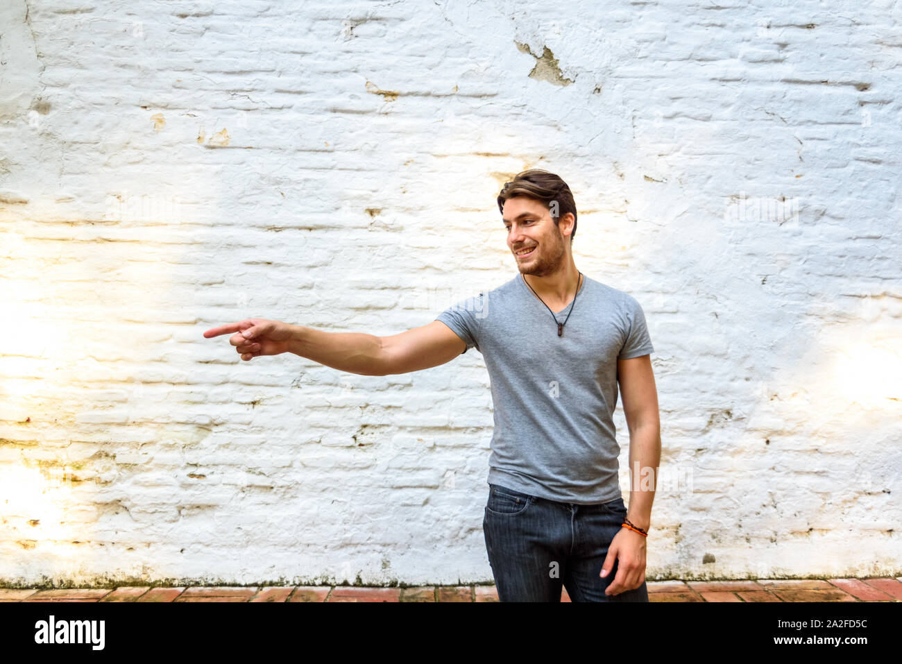Young adult model pointing hi-res stock photography and images - Alamy