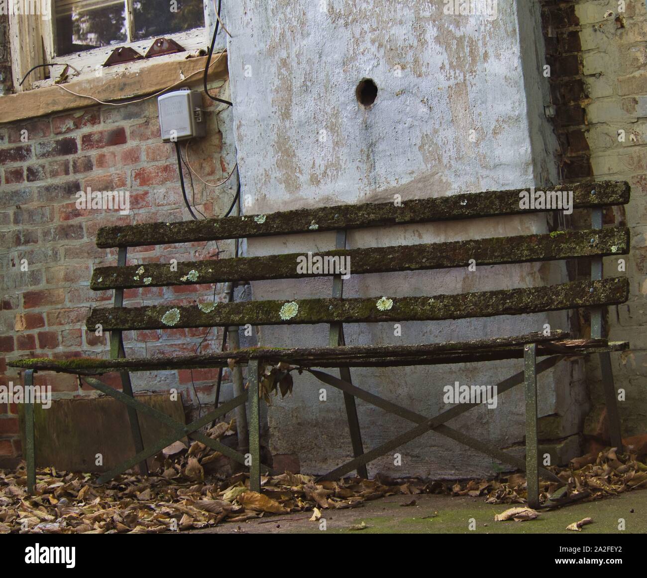 Old park bench setting behind a house Stock Photo - Alamy