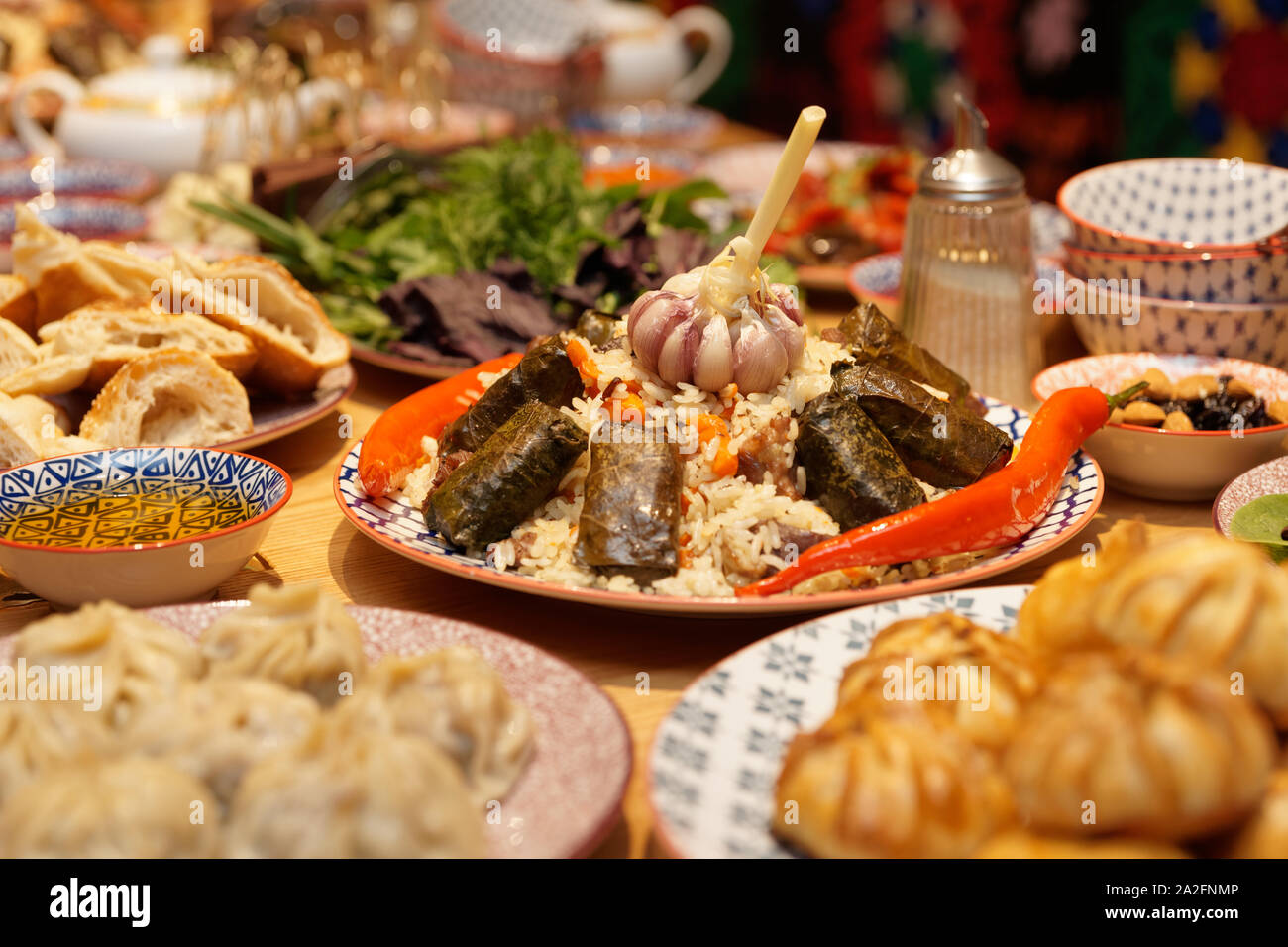 Table served with Uzbek traditional dishes - pilaf, dolma, dumplings ...