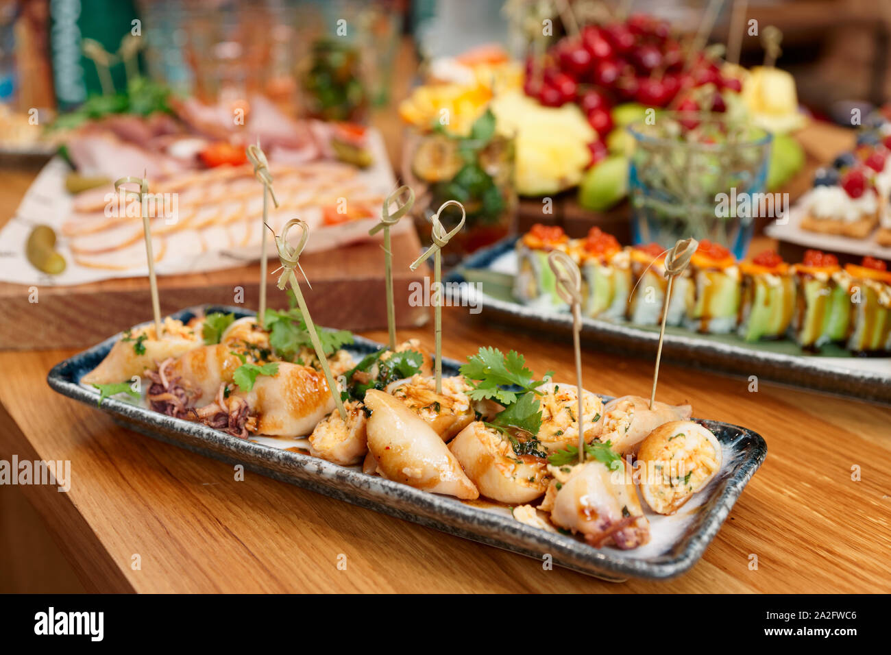 Stuffed squid cooked in Asian style and another food, catering table ...