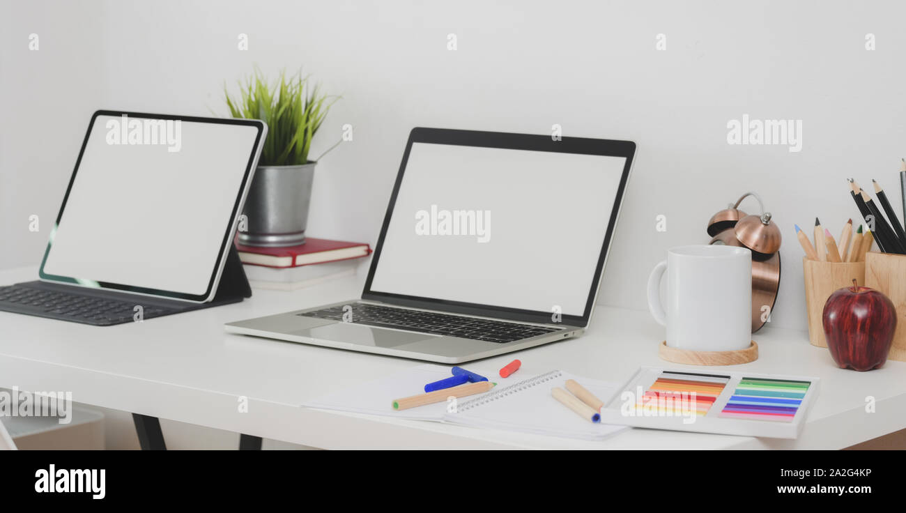 Back to school concept : Blank screen laptop computer and tablet with ...