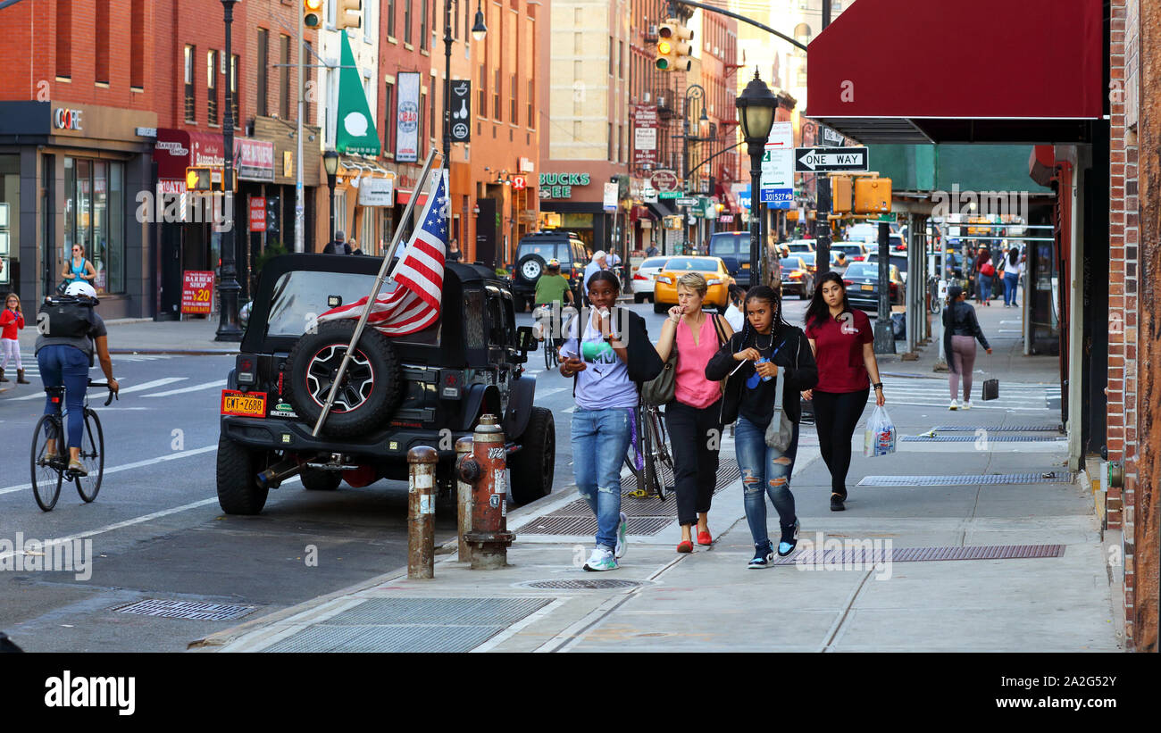 People walk past a jeep with an American flag on Smith Street in the ...