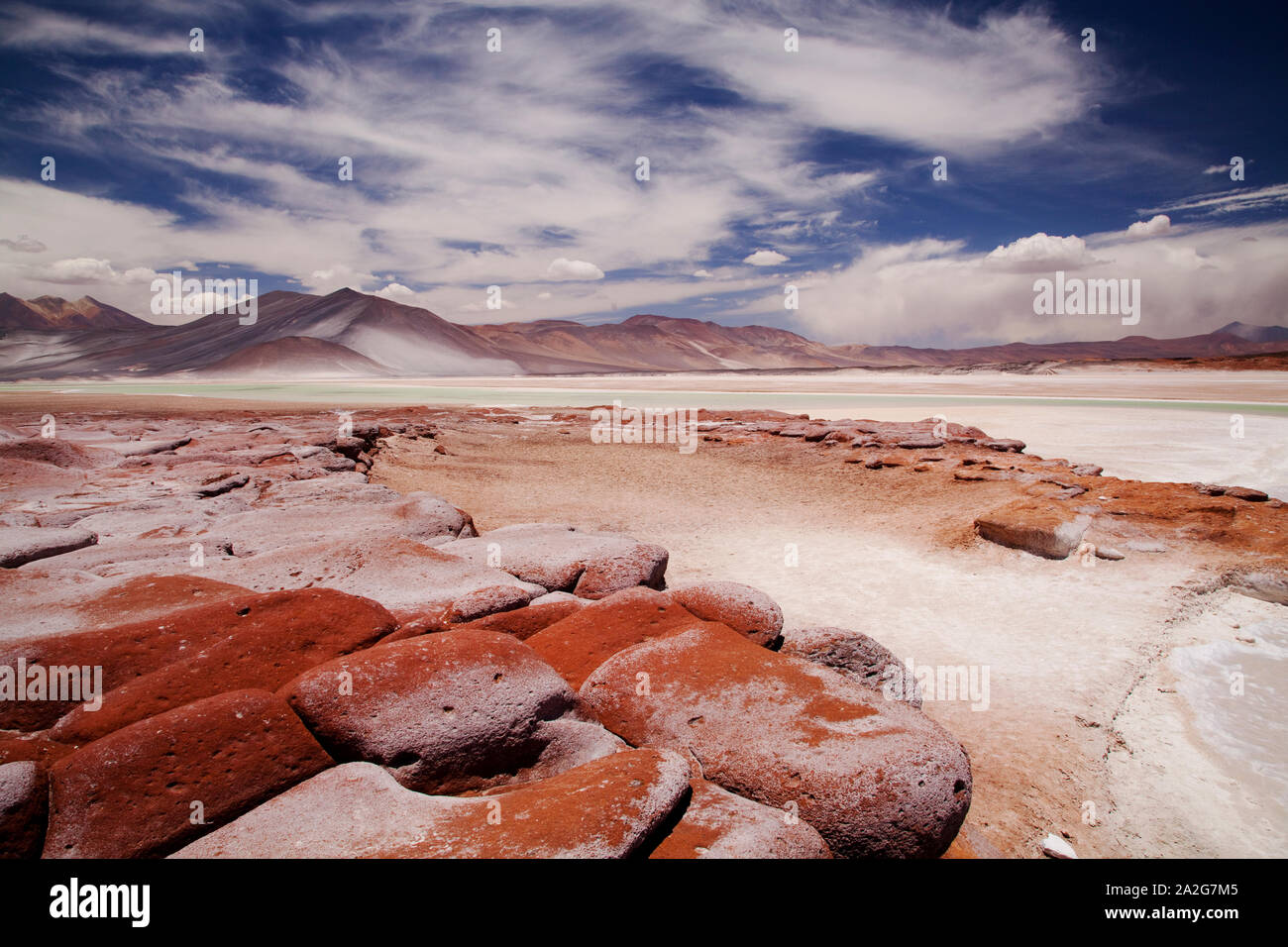 Red Rocks (Piedras Rojas) and lagoon and salt flats in Atacama Desert ...