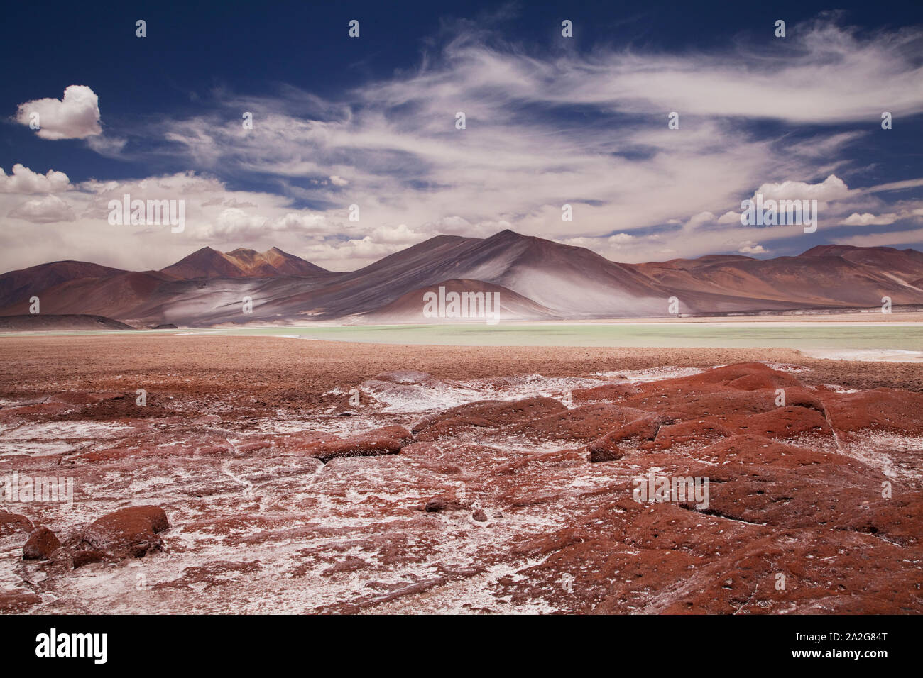 Red Rocks (Piedras Rojas) and lagoon and salt flats in Atacama Desert ...