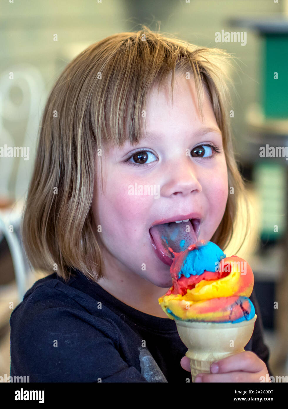 cute little girl enjoys a colorful ice cream cone Stock Photo - Alamy