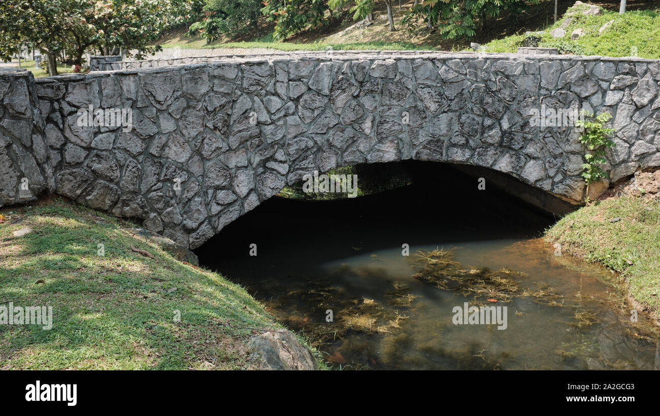 Stone bridge over stream Stock Photo - Alamy