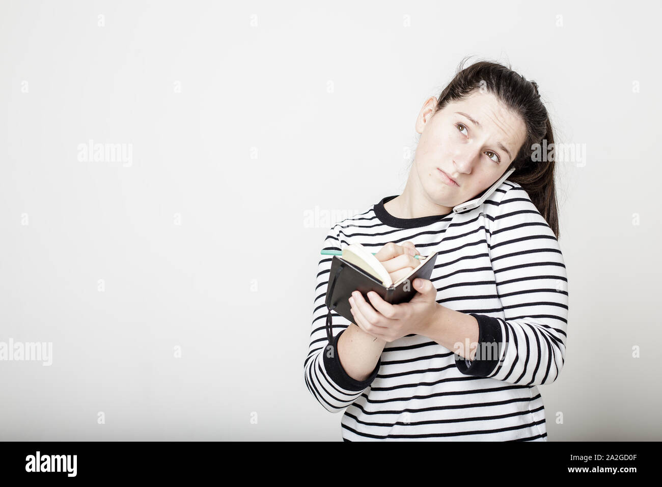 Serious woman talking note book hi-res stock photography and images - Alamy