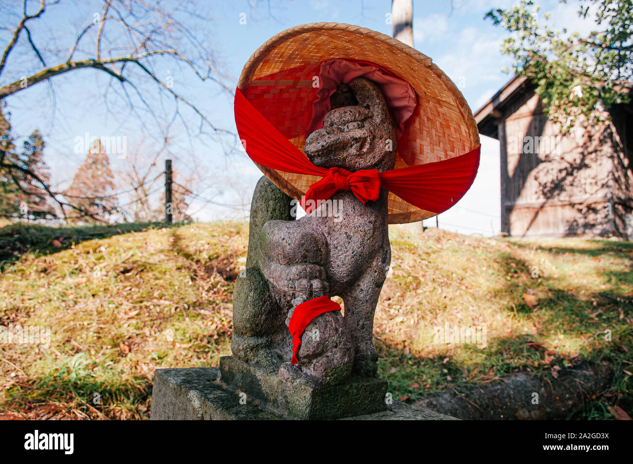 Kitsune Japanese Fox stone statue with red scarft and hat at shrine of ...