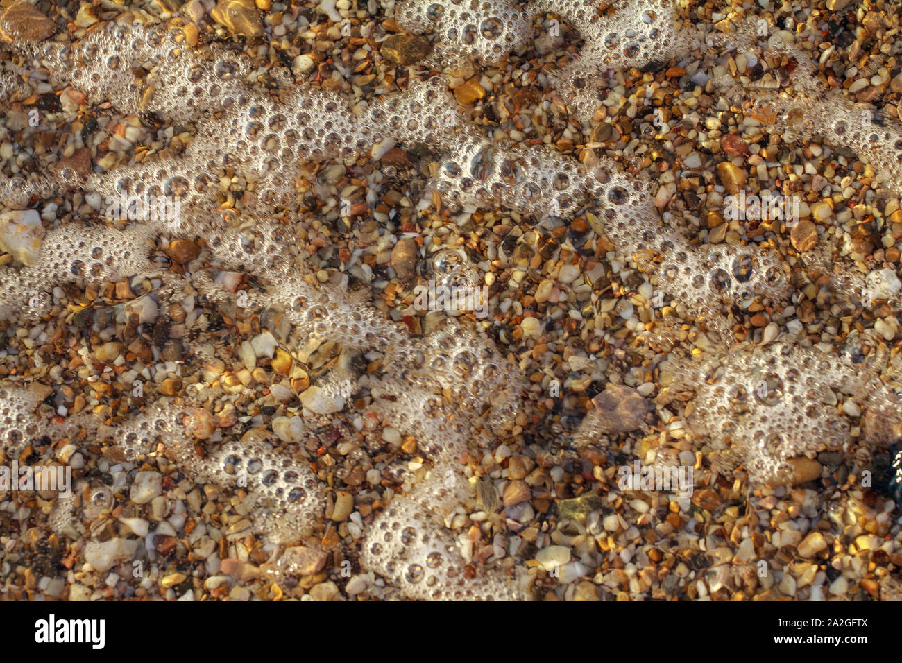 sea pebbles colored granite on the beach background stones. The shore ...