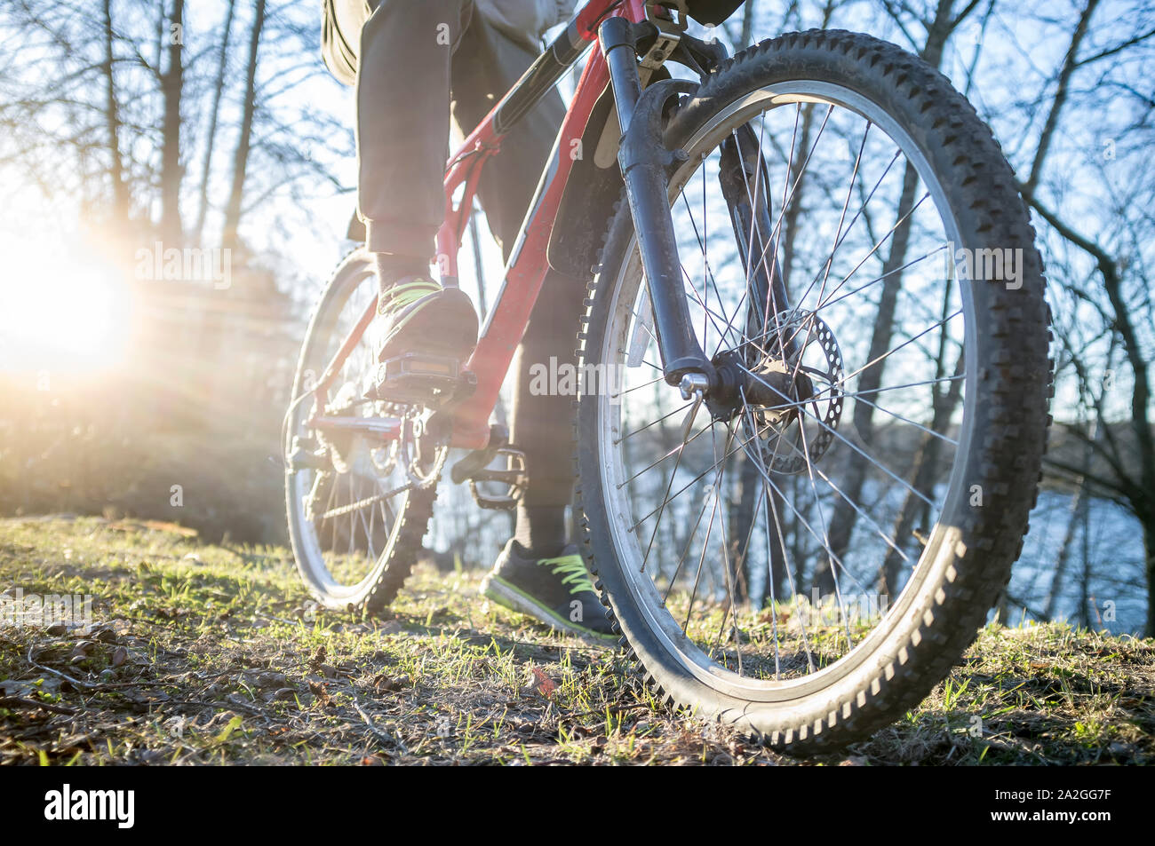 Cyclist resting after a ride along the banks of the river, spring ...