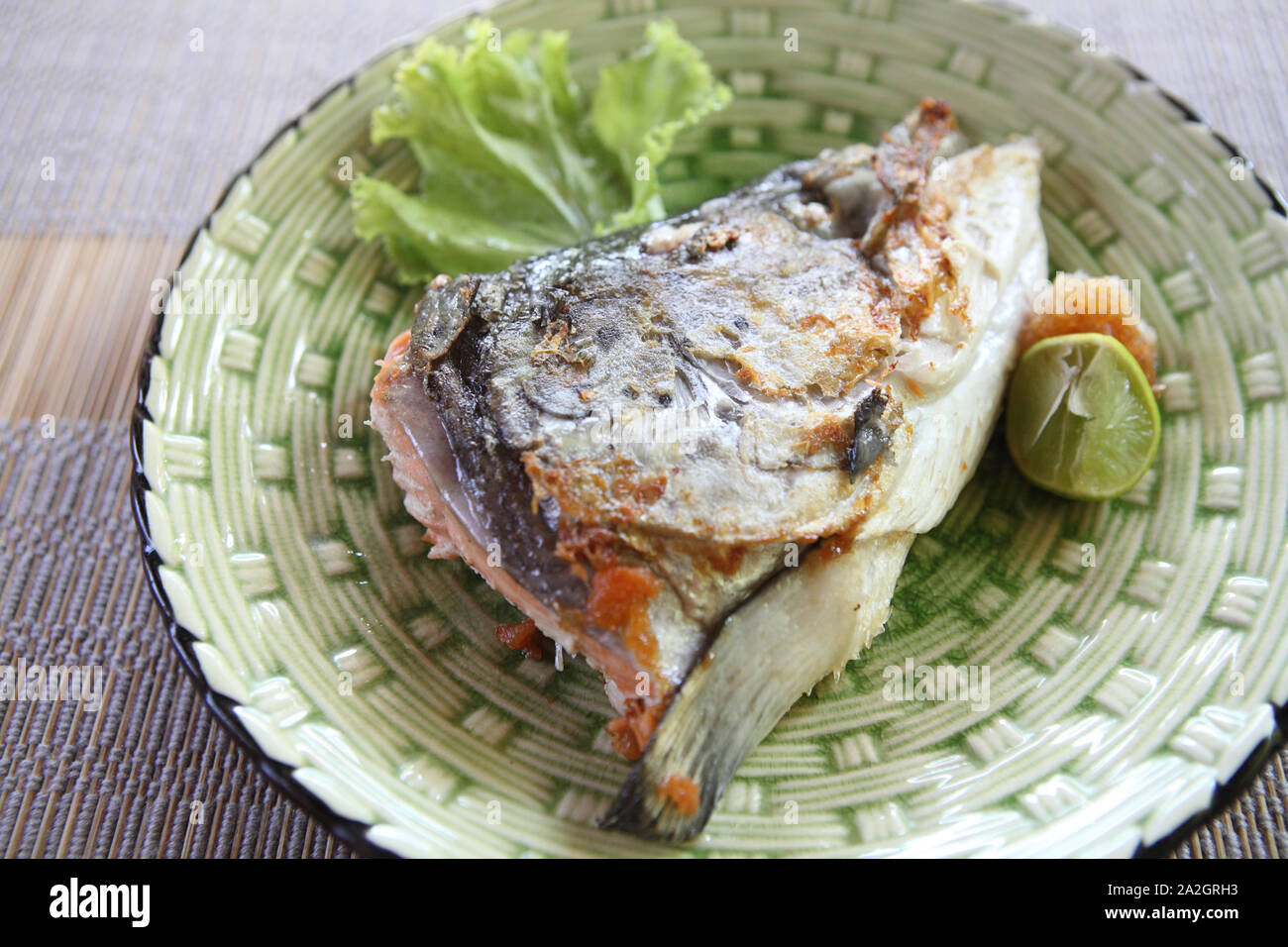 Japanese food Grilled head fish Stock Photo - Alamy