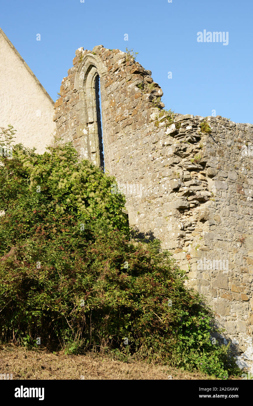 The wall of the Monastery at Penmon priory leaning due to age. The ...