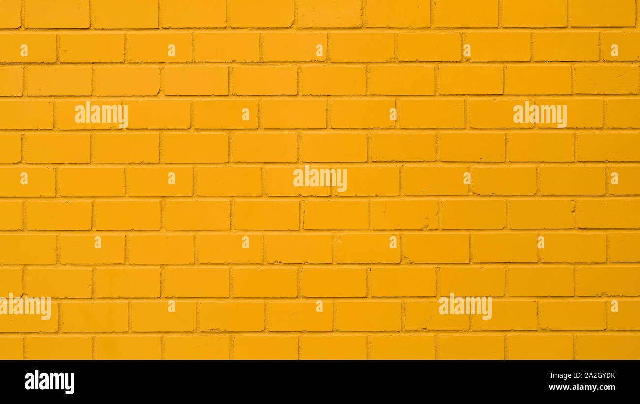 Yellow brick wall as background Stock Photo - Alamy