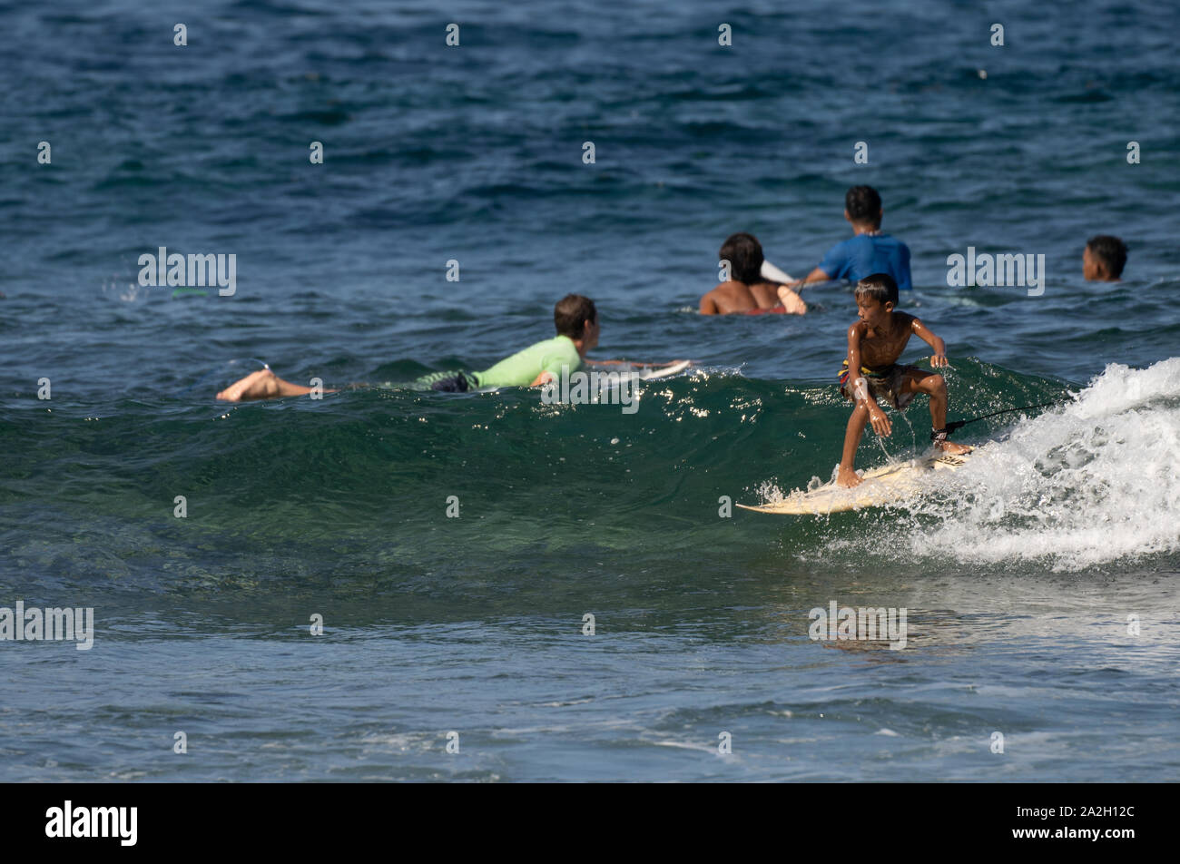 A young boy surfing at the famous Cloud 9 surf break,Siargao ...