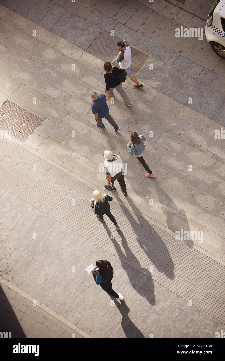 People walking on a pavement Stock Photo - Alamy