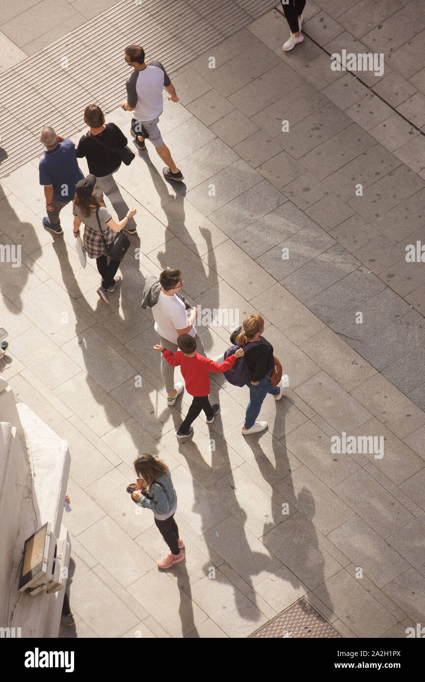 People walking on a pavement Stock Photo - Alamy