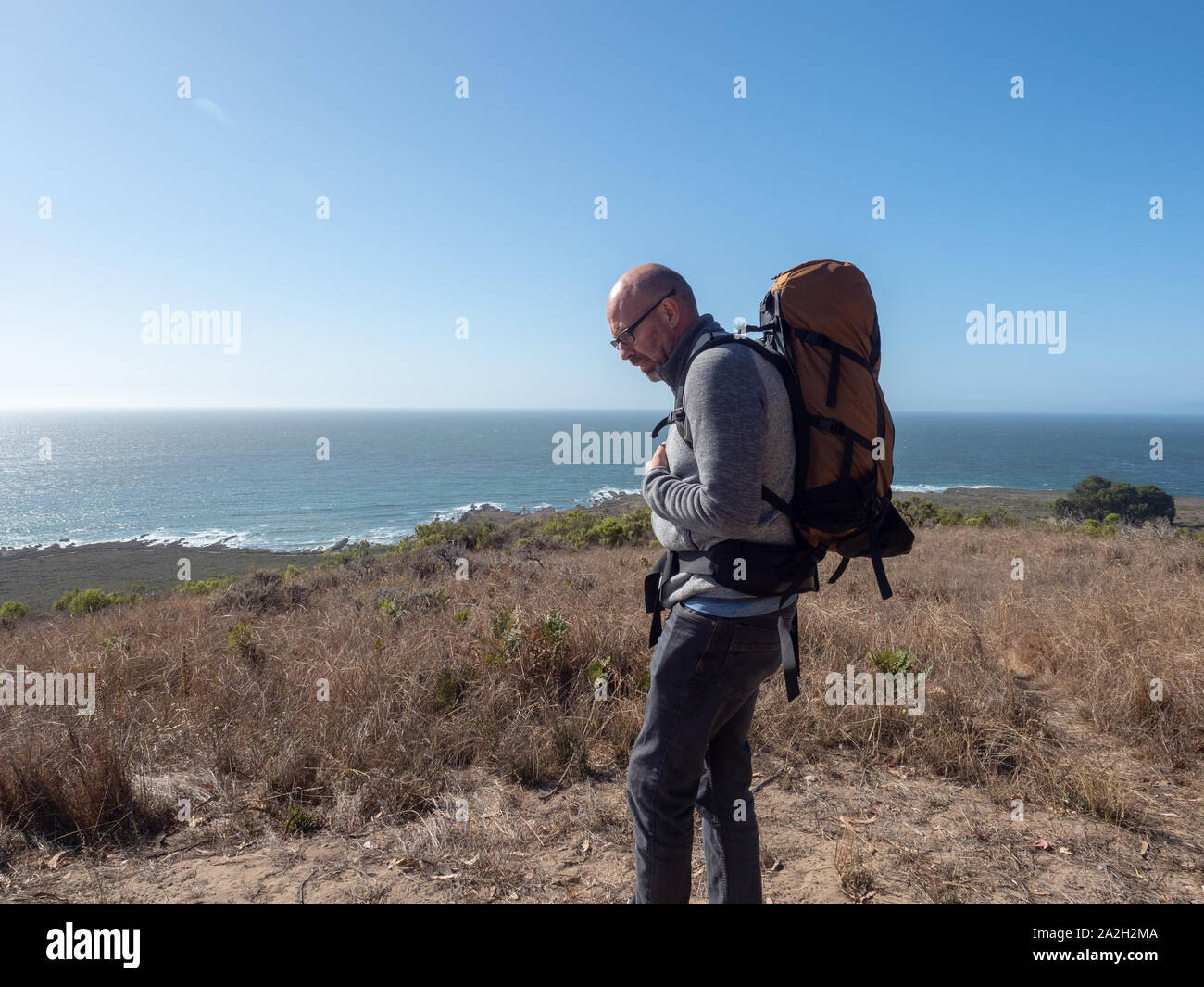 Man backpacking on bluff above ocean, Montana de Oro State Park, Los ...