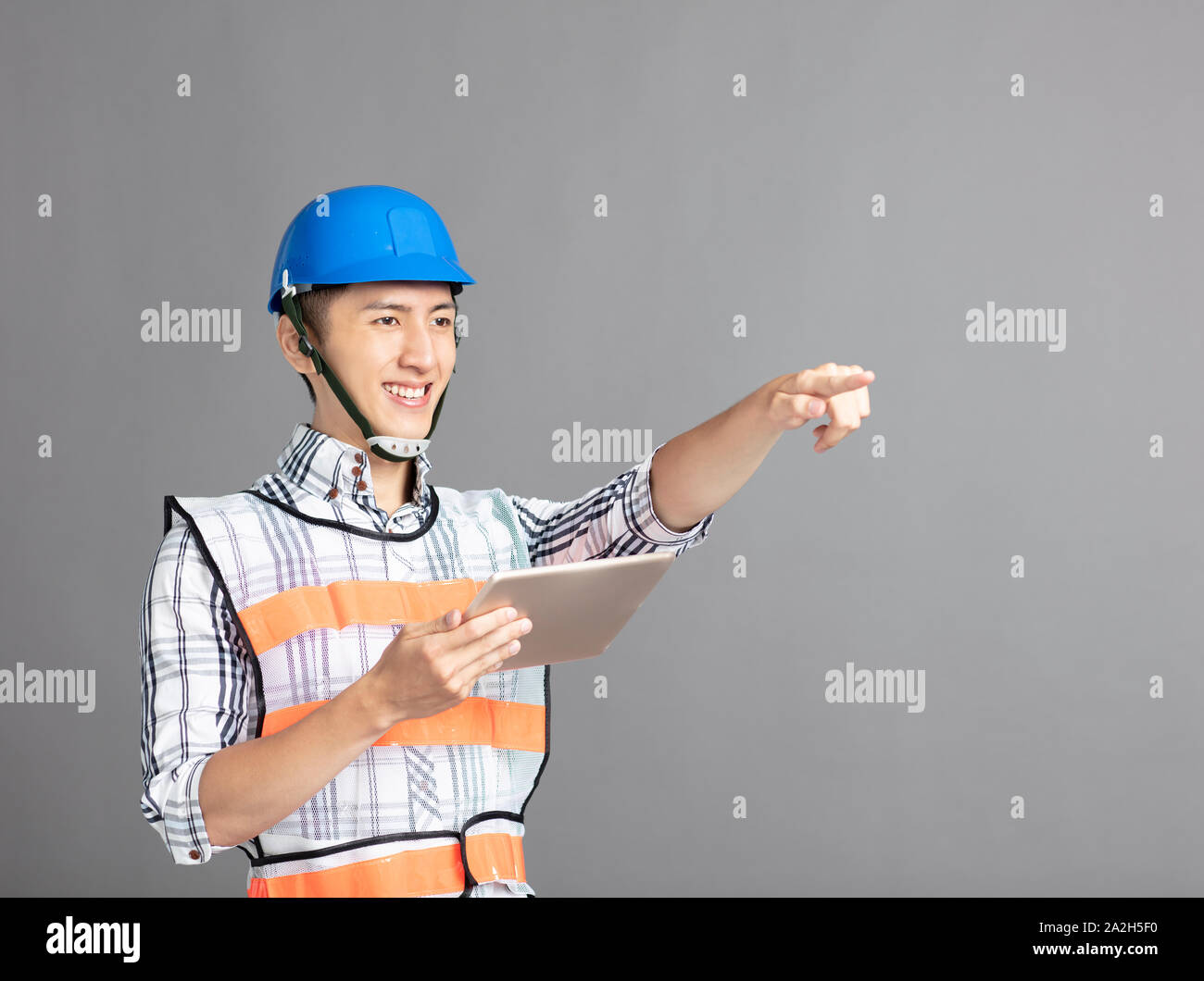 smiling asian young man construction worker Stock Photo - Alamy