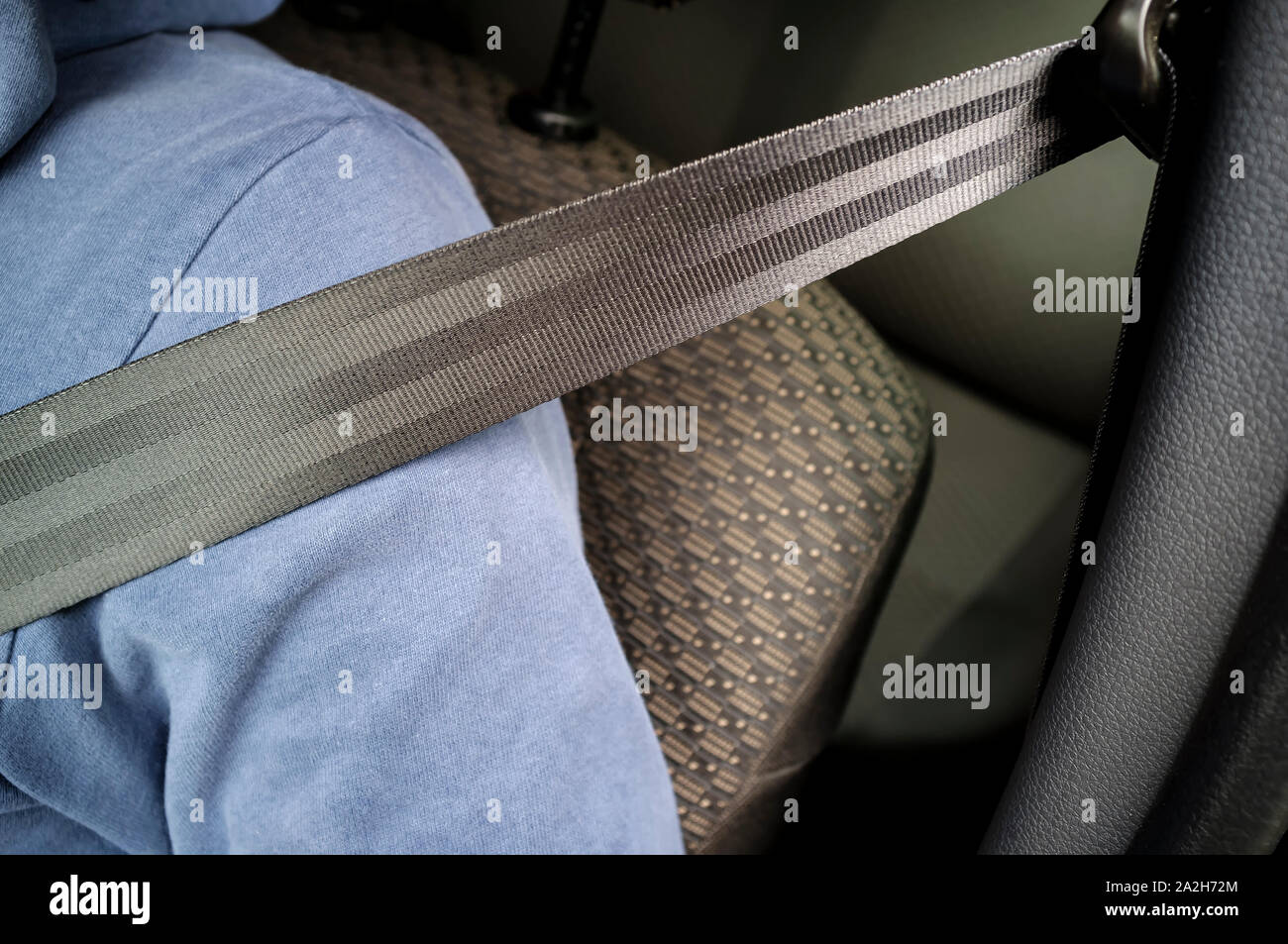 Driver man is fastened with a safety belt while driving the car Stock ...