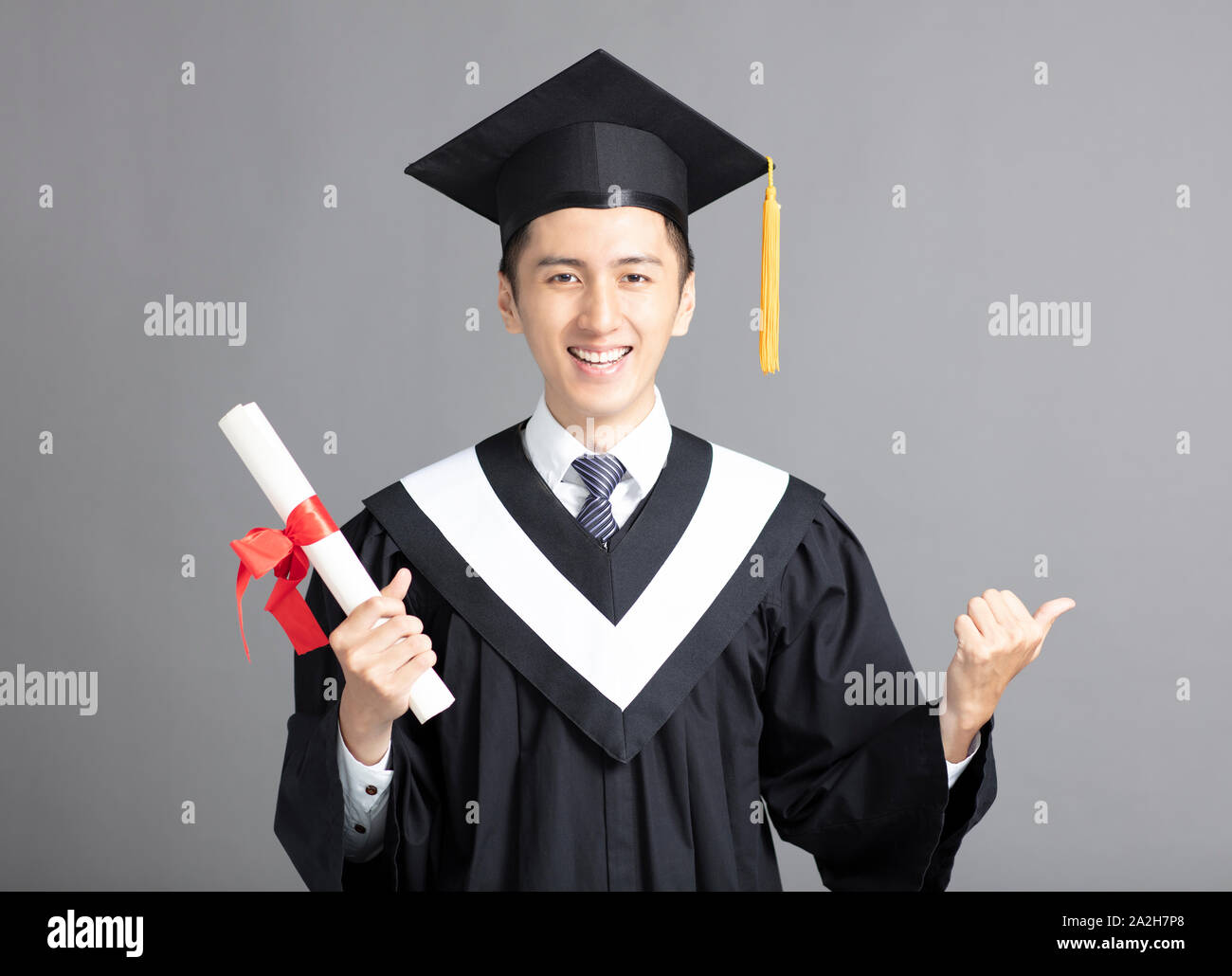 Cheerful young graduated student man isolated Stock Photo - Alamy