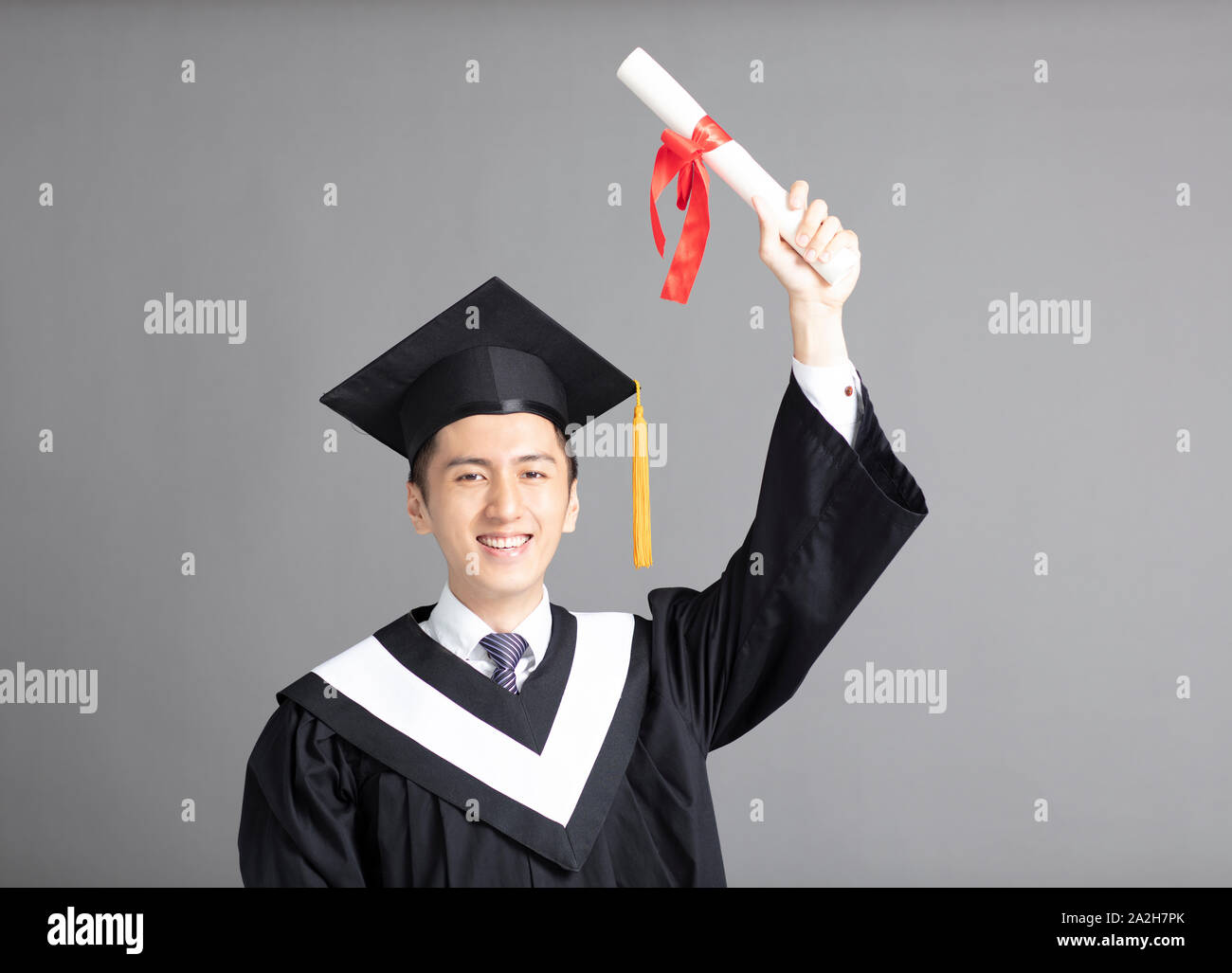 Cheerful young graduated student man isolated Stock Photo - Alamy