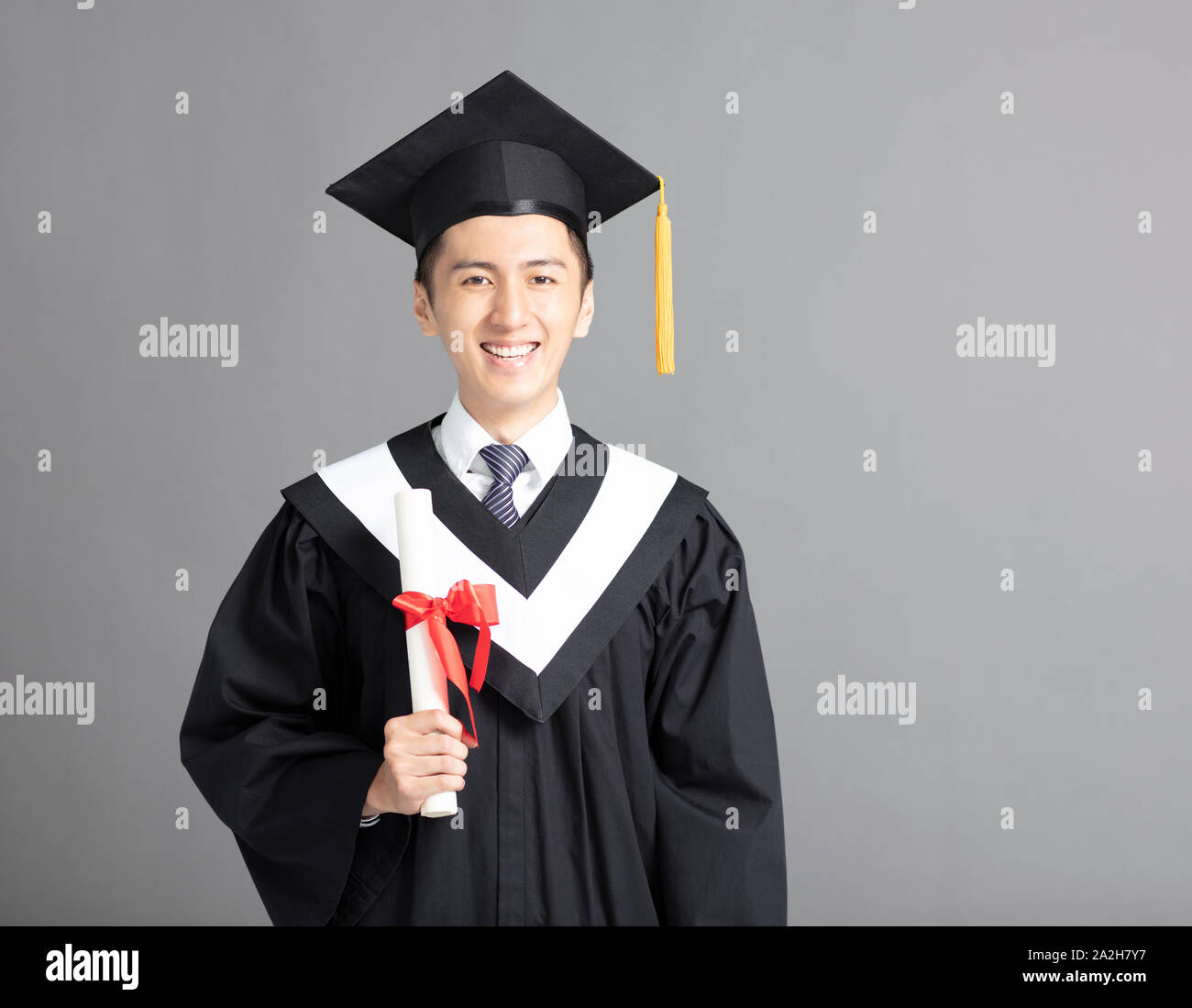 Cheerful young graduated student man isolated Stock Photo - Alamy