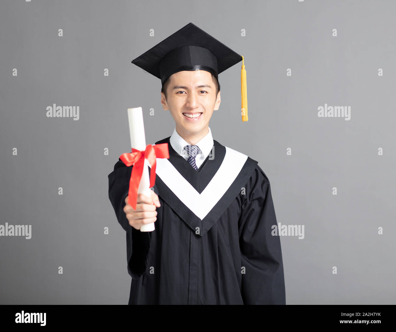 Cheerful young graduated student man isolated Stock Photo - Alamy