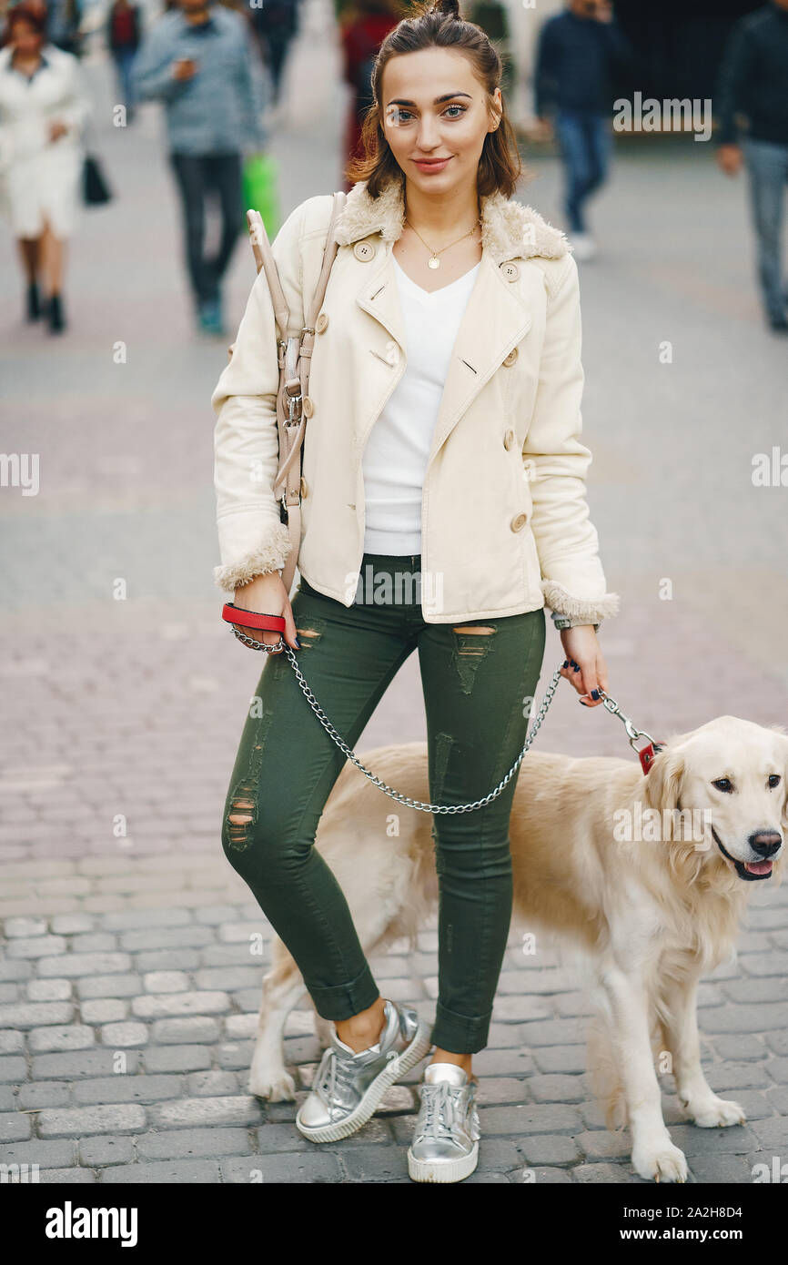 beautiful woman walking her dog in the city during the day Stock Photo ...