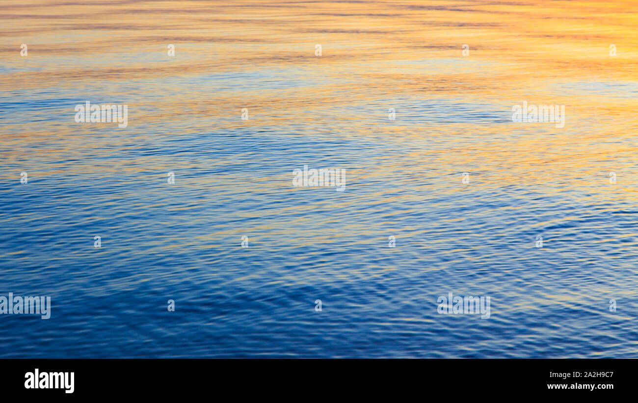 Clear water texture in blue and orange. Background of the ocean and the ...