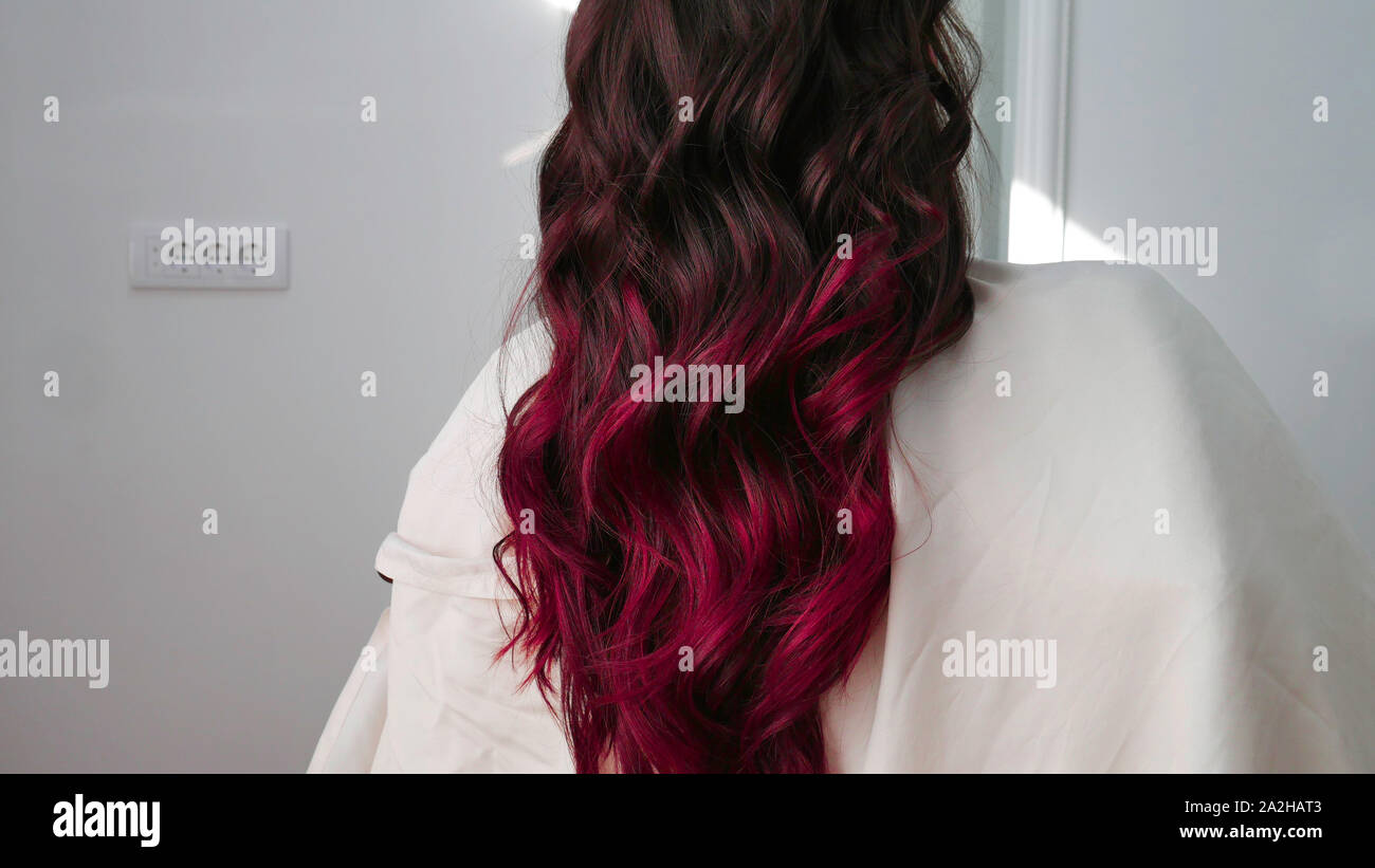 Long healthy red colored hair - The model sits in a hairdressing chair ...