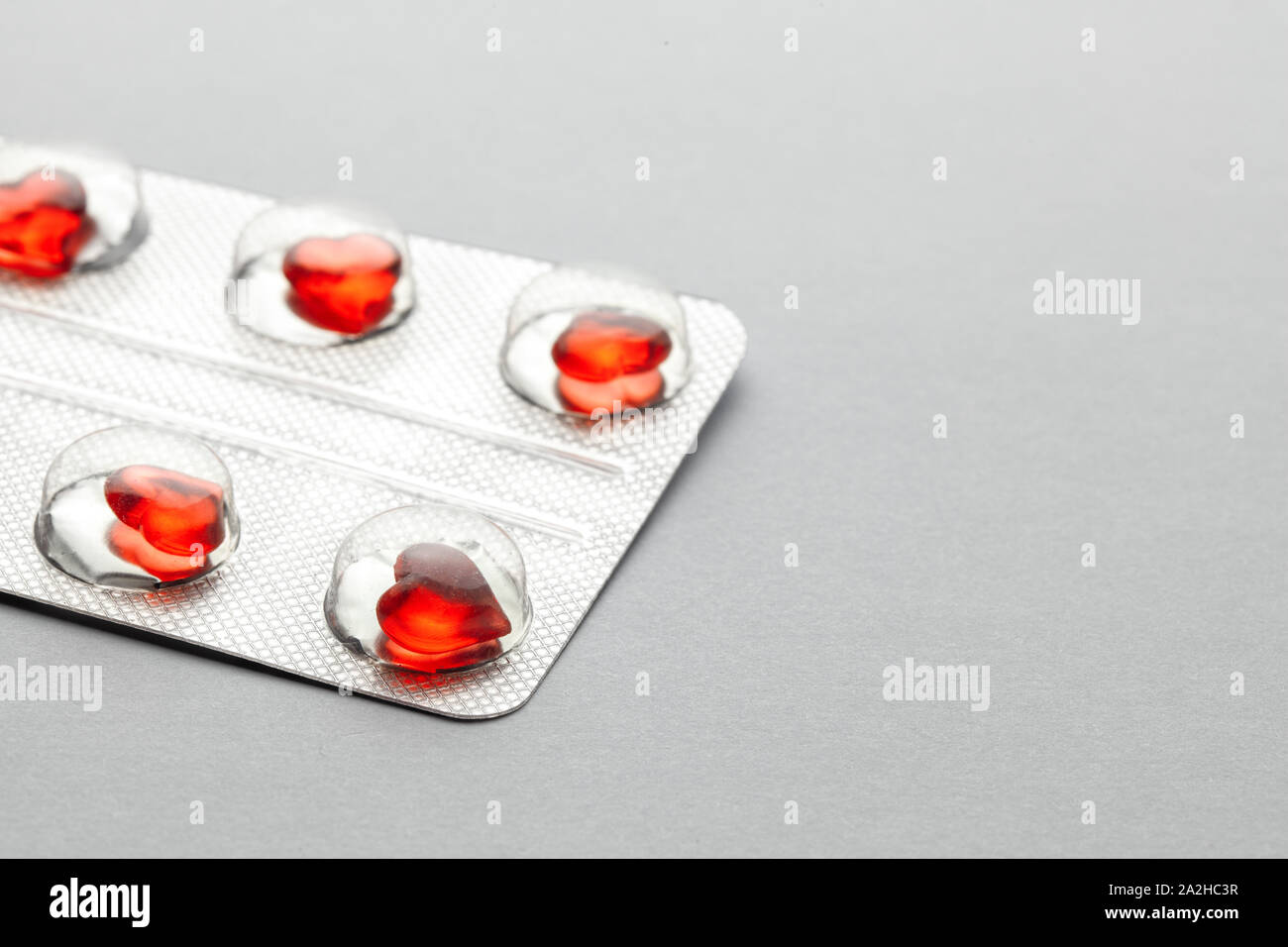 Love pills. Blister pack with red heart shaped pills. Tablets for ...