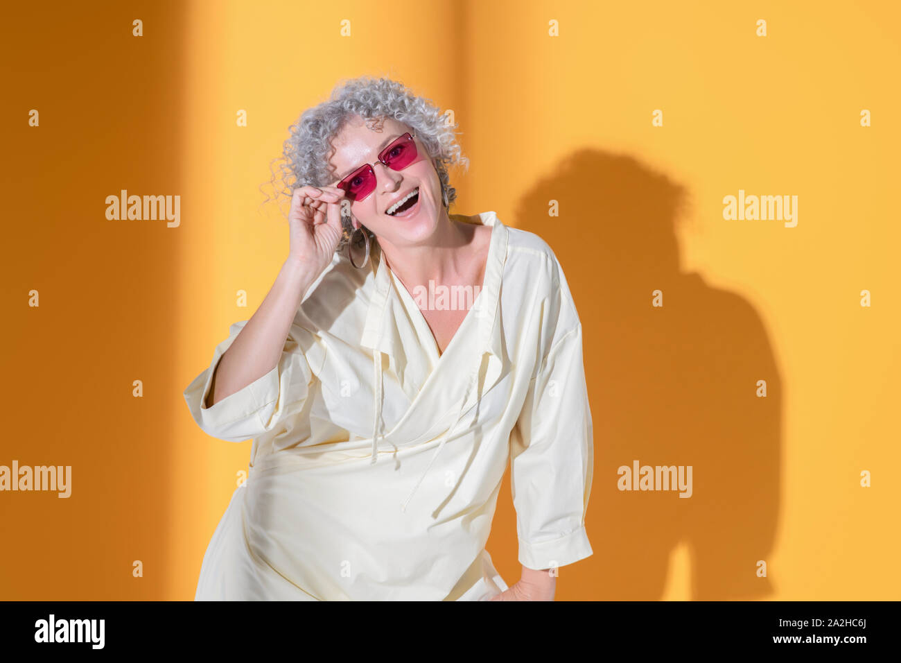 Woman laughing while feeling positive and excited Stock Photo - Alamy