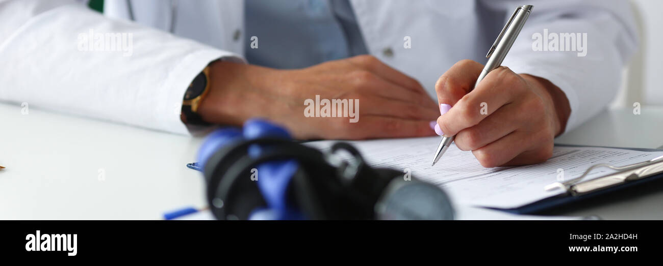 Female doctor hand write silver pen prescription paper Stock Photo - Alamy