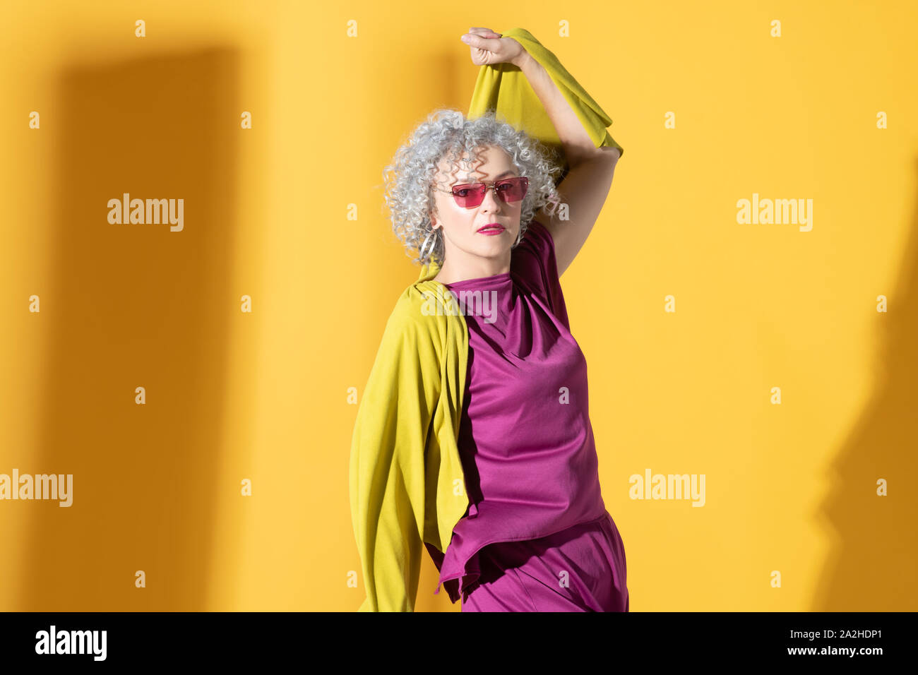 Beautiful woman wearing bright clothing and sunglasses Stock Photo - Alamy