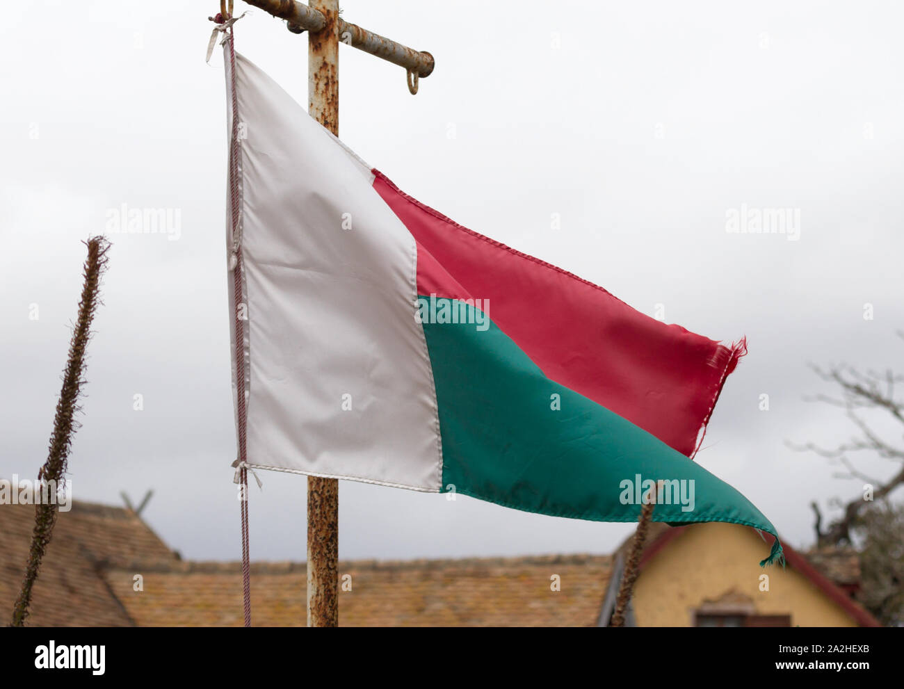 Flag of Madagascar waving in a Malagasy village Stock Photo - Alamy