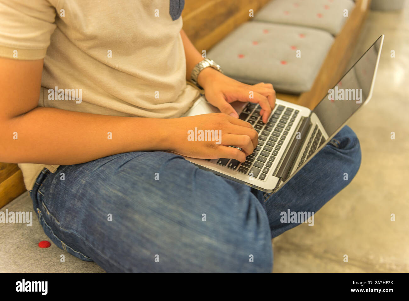 Human comfortably sitting on bench and typing laptop keyboard Stock ...