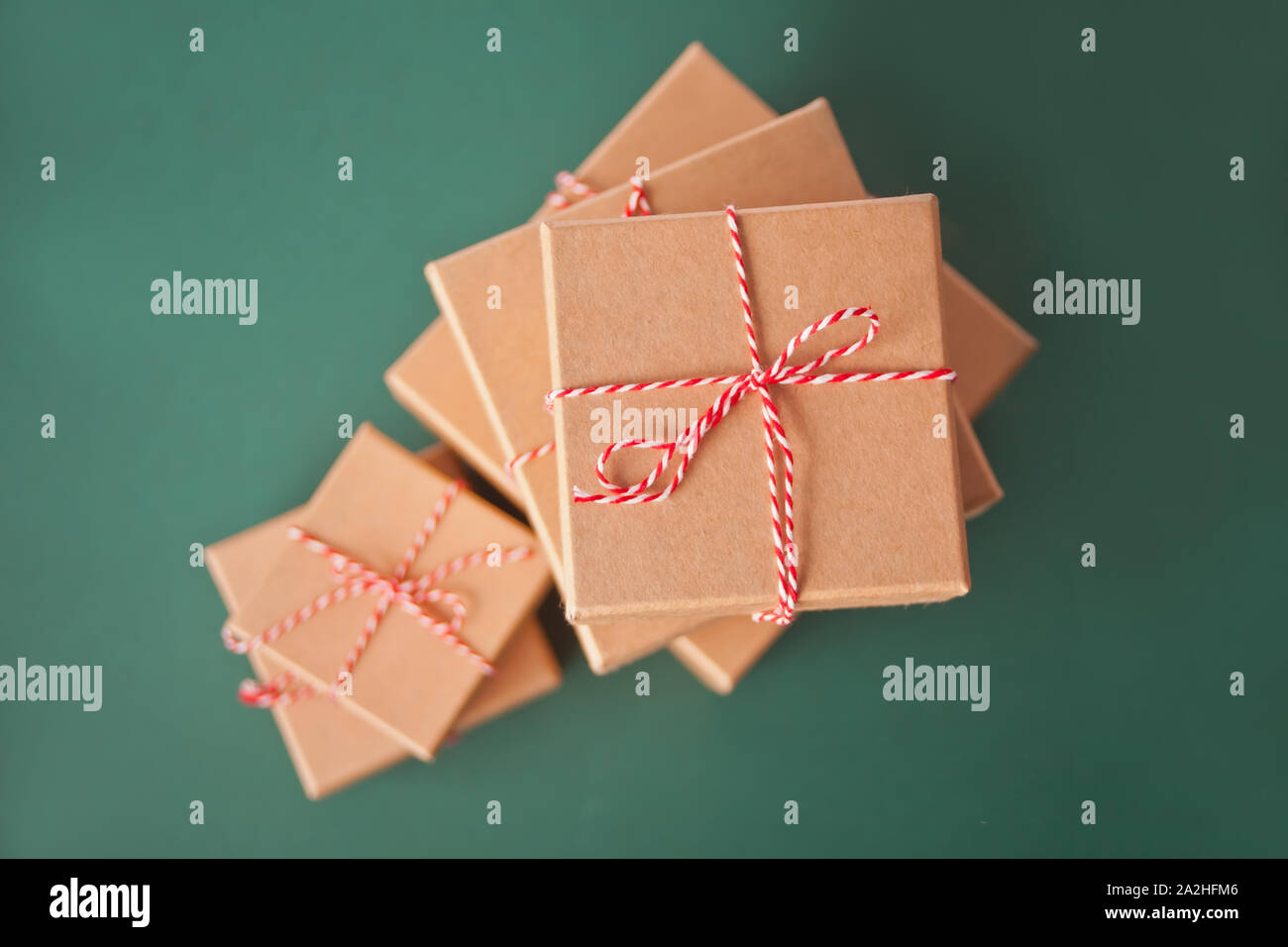 Five different sizes Christmas gift boxes on the green background Stock ...