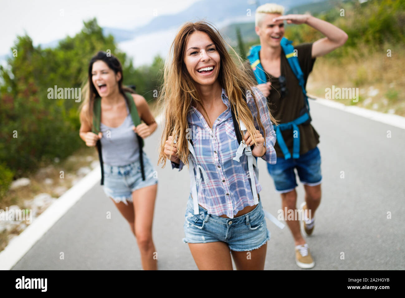 Group of friends backpackers walking and traveling outdoor Stock Photo ...