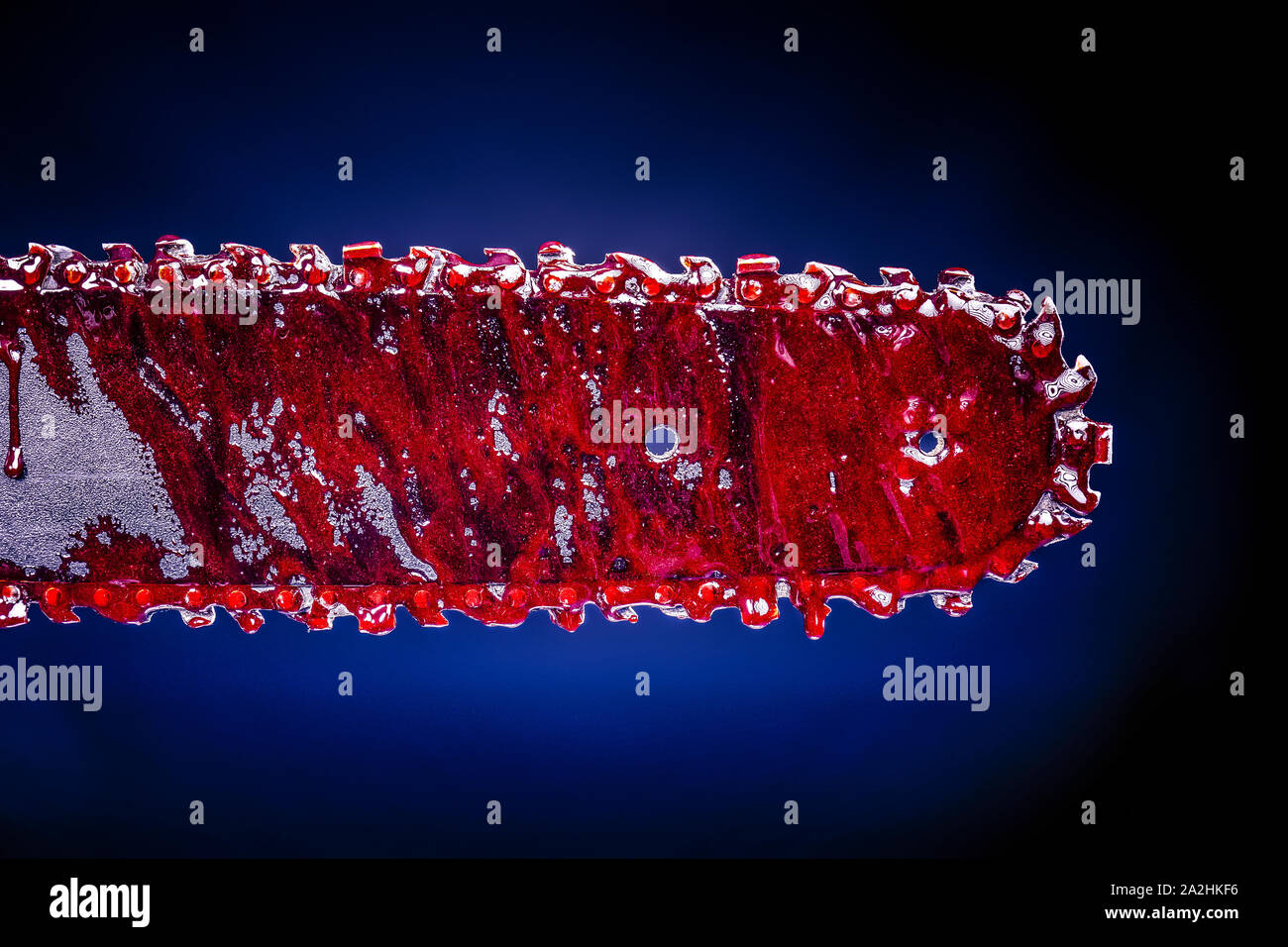 detail of a chain saw covered in blood. Image suitable for horror or ...