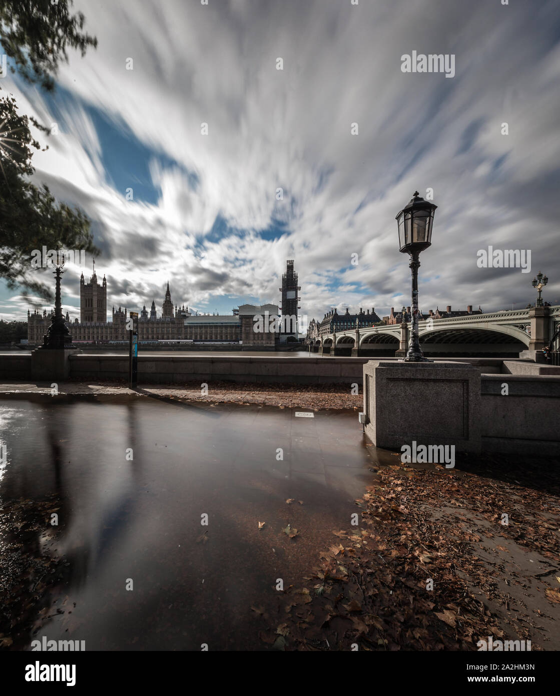 Fluffy white clouds stretch over the houses of parliament following the ...