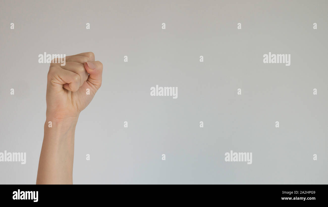 Isolated woman's right hand clenched in fist Stock Photo - Alamy