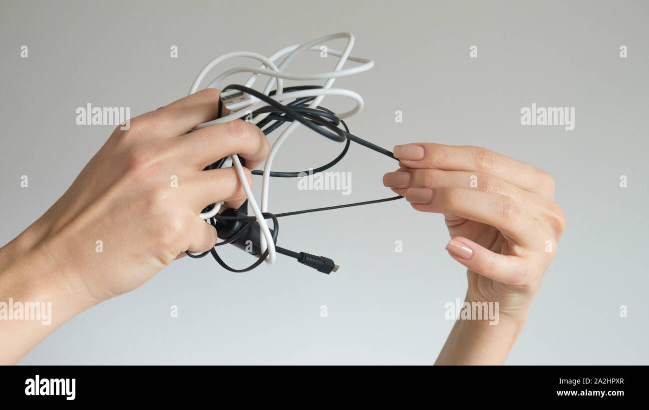 Black and white cables in a woman's hand on isolated background Stock ...