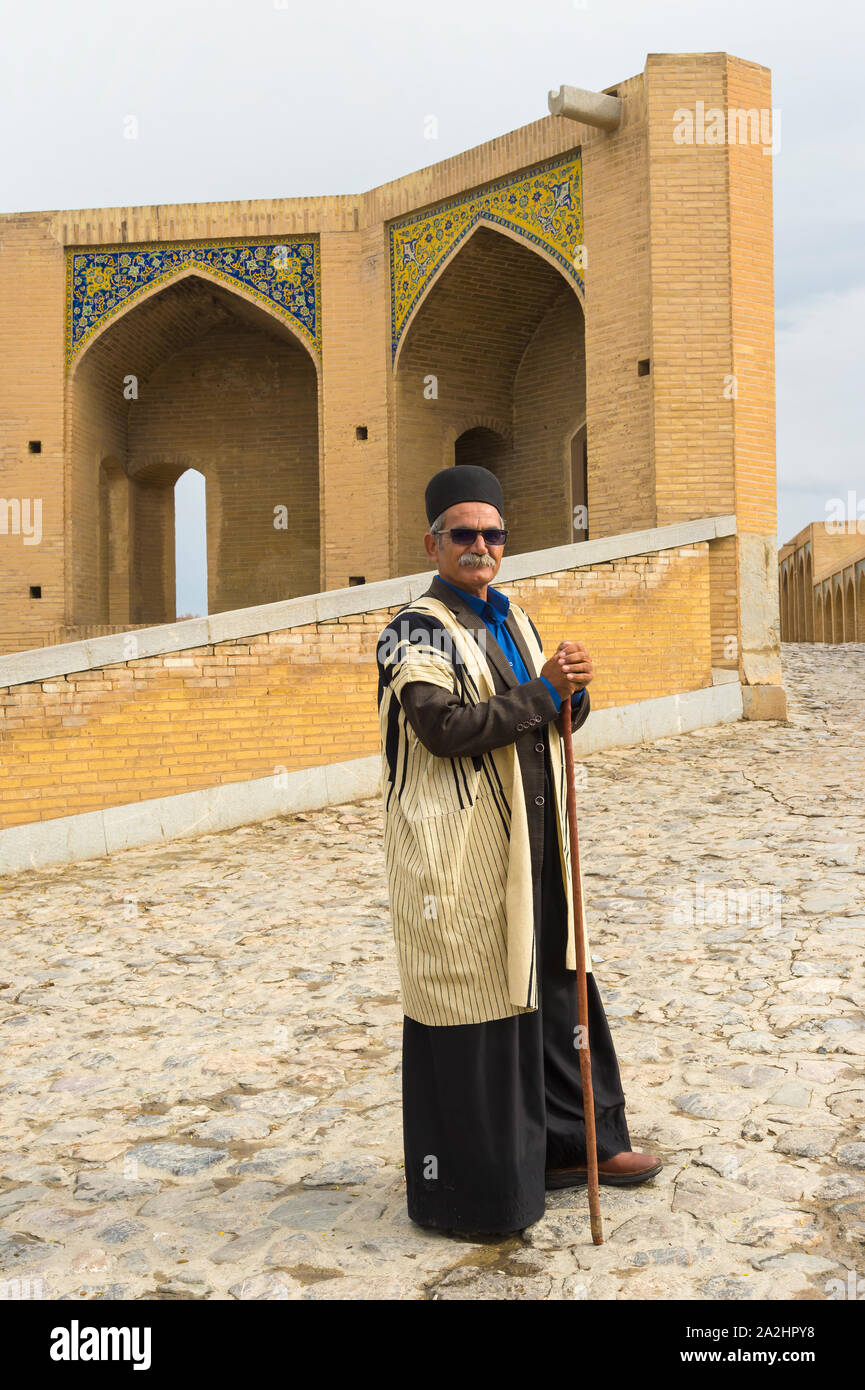 Iranian man in traditional attire on Pol-e Khadju bridge over ...