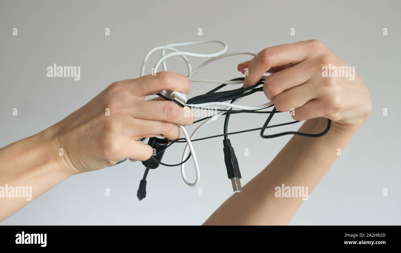 Black and white cables in a woman's hand on isolated background Stock ...