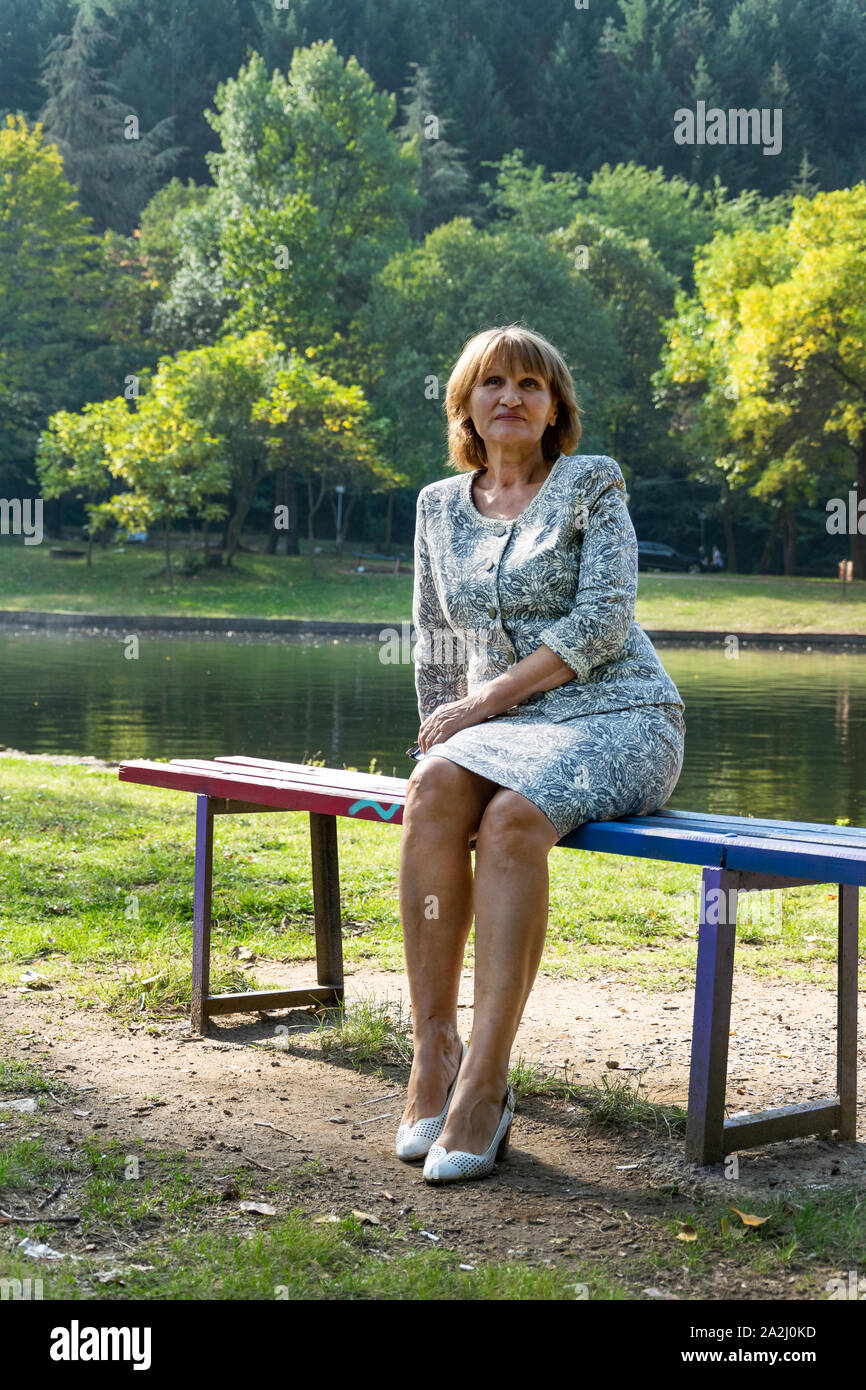 Attractive senior lady in the park. Healthy and active lifestyle ...