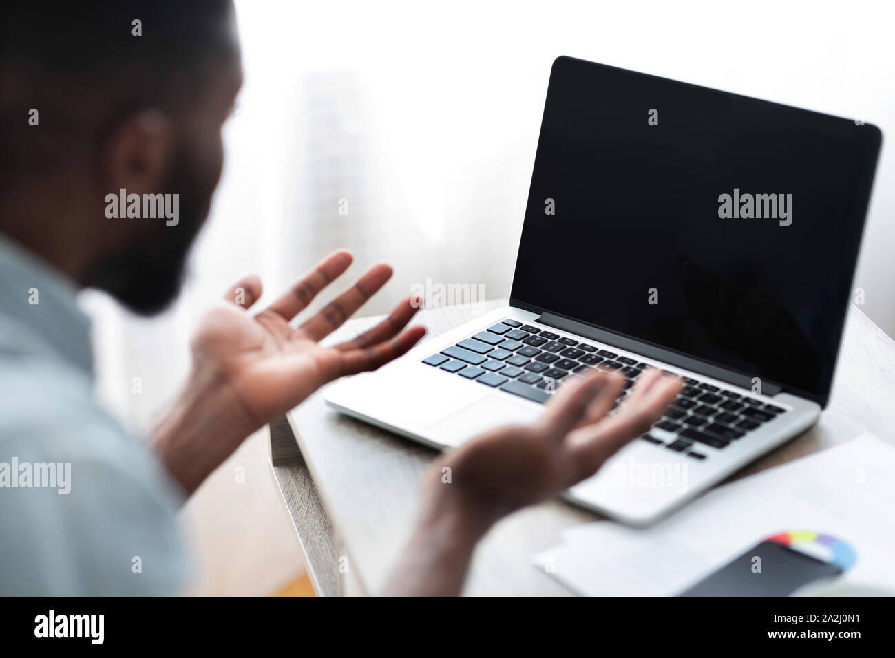Worried african american man looking at laptop with blank screen Stock ...